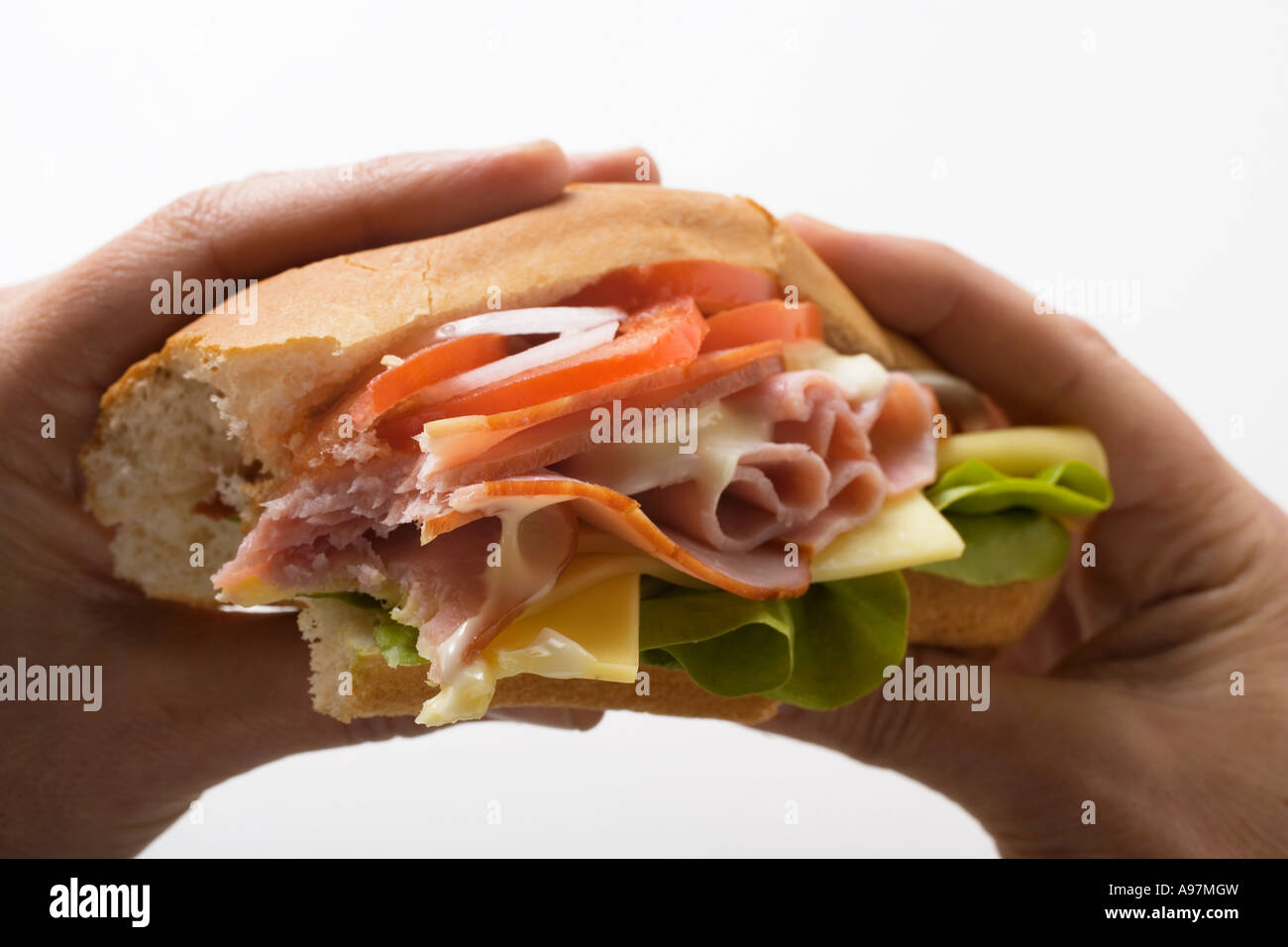 Hands holding ham and cheese sub sandwich FoodCollection Stock Photo ...