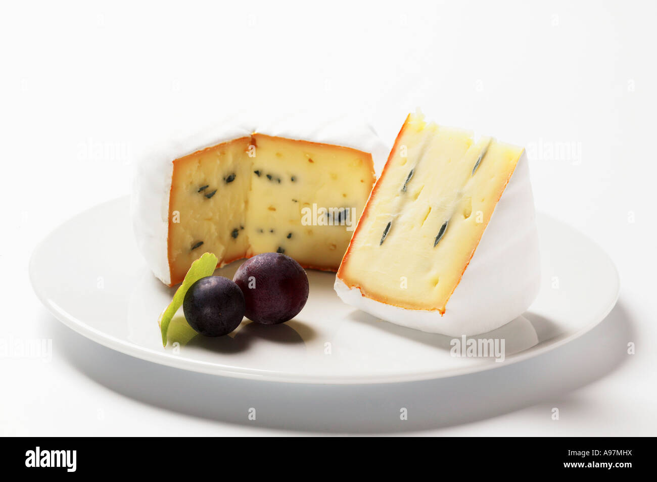 Blue cheese Bavaria blue with red grapes on plate FoodCollection Stock ...
