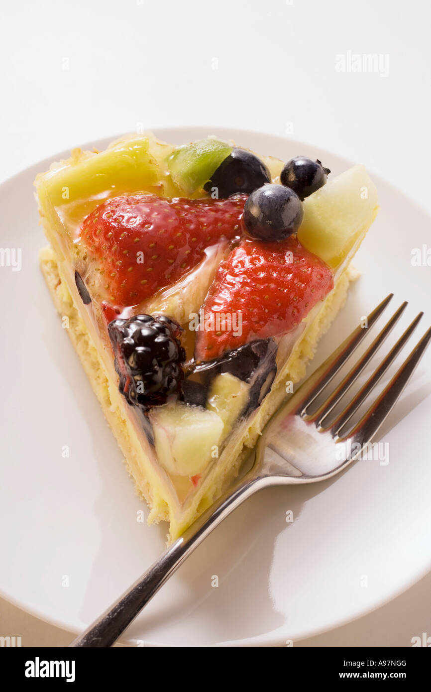 Piece of fruit gateau with fork FoodCollection Stock Photo - Alamy