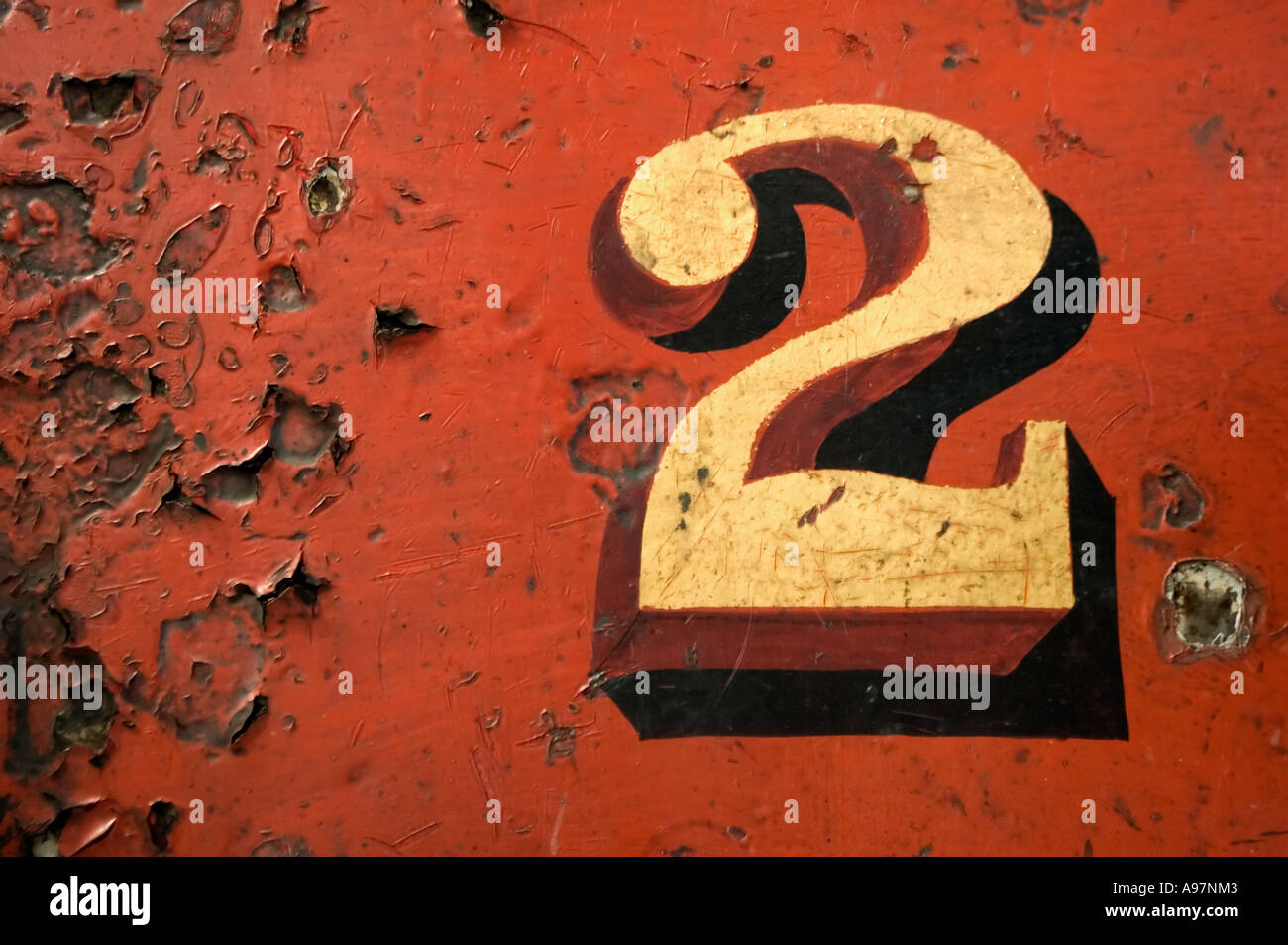 Yellow number two(2) on a red background Stock Photo - Alamy