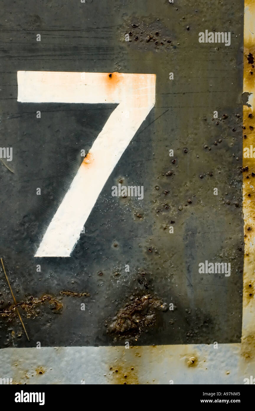 White number seven (7) on a rusty grey background Stock Photo - Alamy