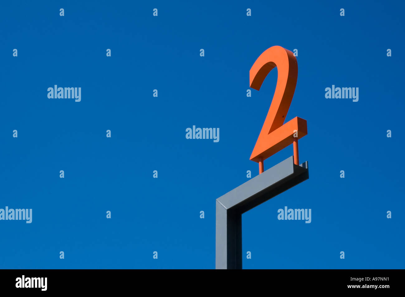 Orange number two (2) against a blue background Stock Photo - Alamy