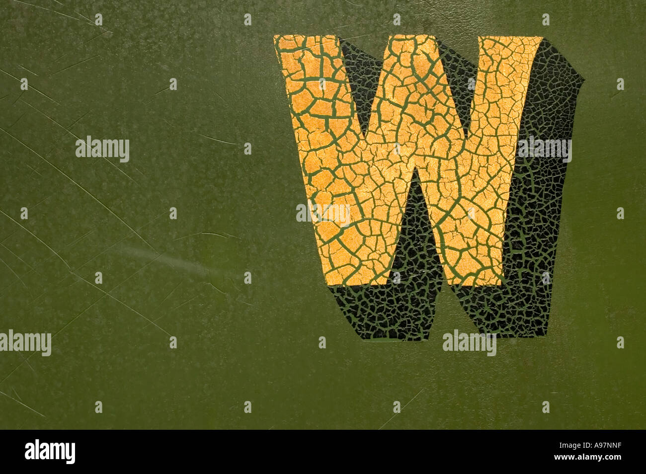 Yellow letter W against a green background Stock Photo - Alamy