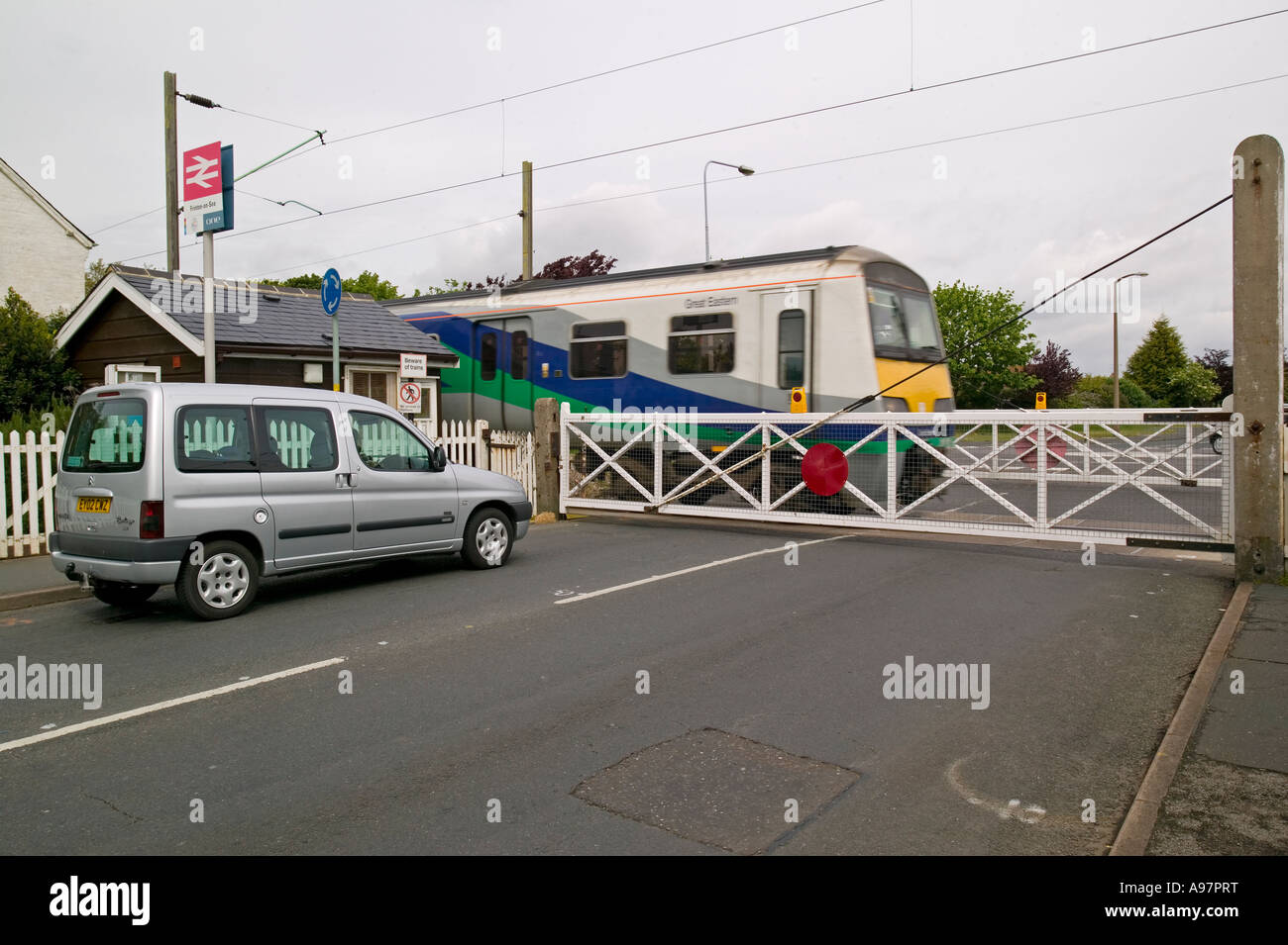 car waiting for a train at a manned level crossing Stock Photo - Alamy