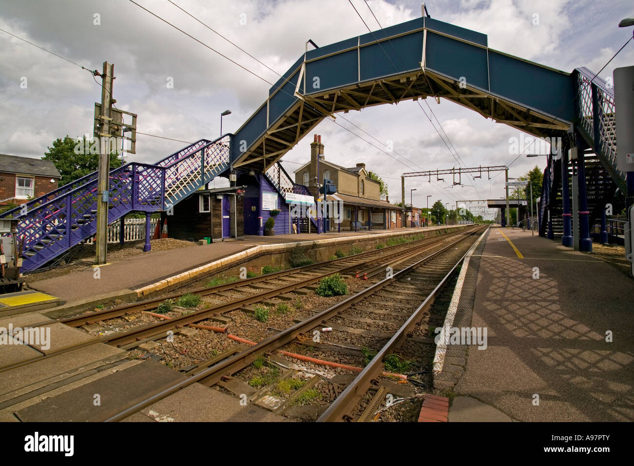 footbridge over rail tracks at great bentley Stock Photo - Alamy
