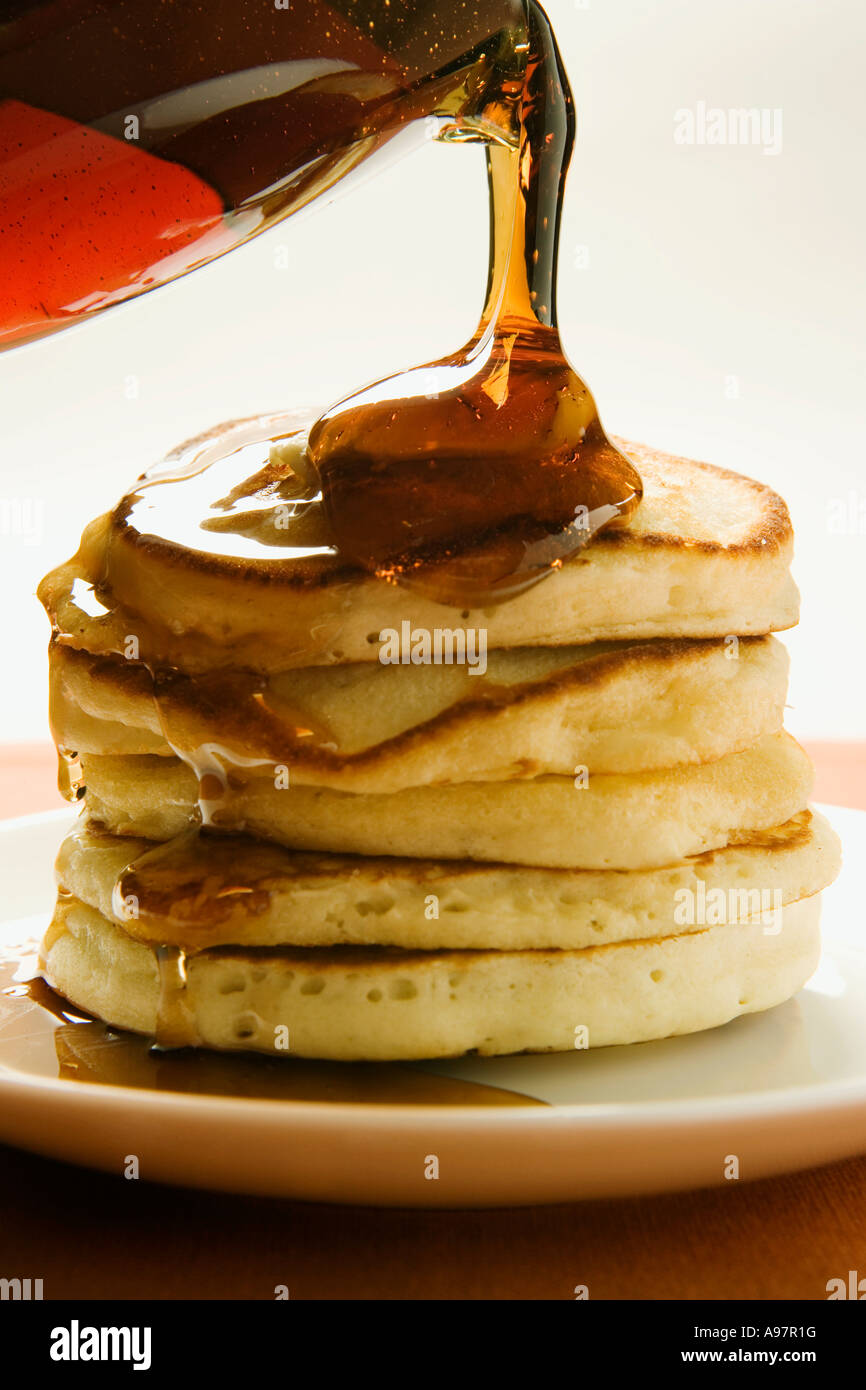 Pouring maple syrup over pancakes FoodCollection Stock Photo - Alamy