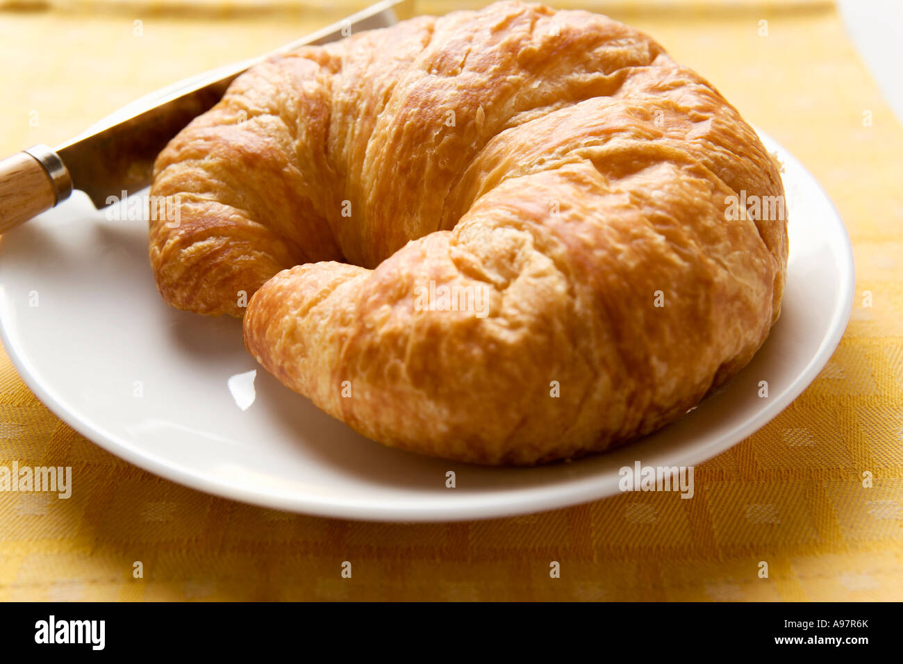 A croissant on a plate FoodCollection Stock Photo - Alamy