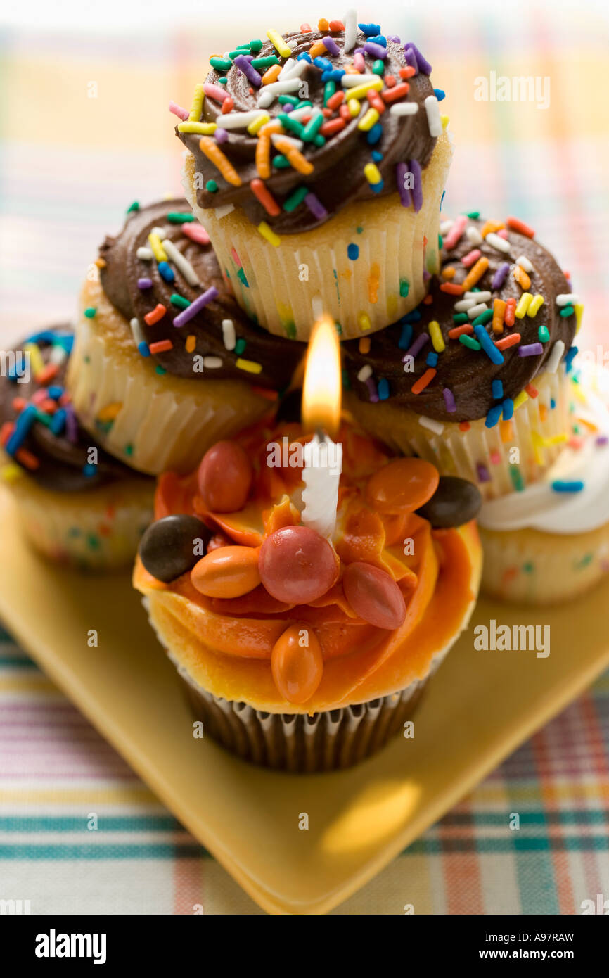 Assorted muffins one with birthday candle FoodCollection Stock Photo ...
