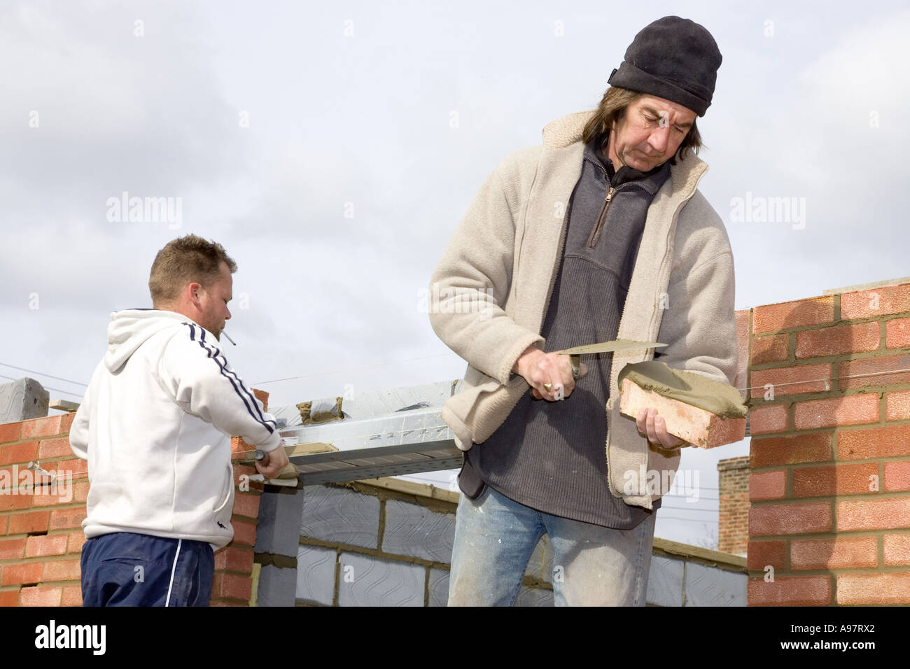 bricklayers constructing a wall Stock Photo - Alamy
