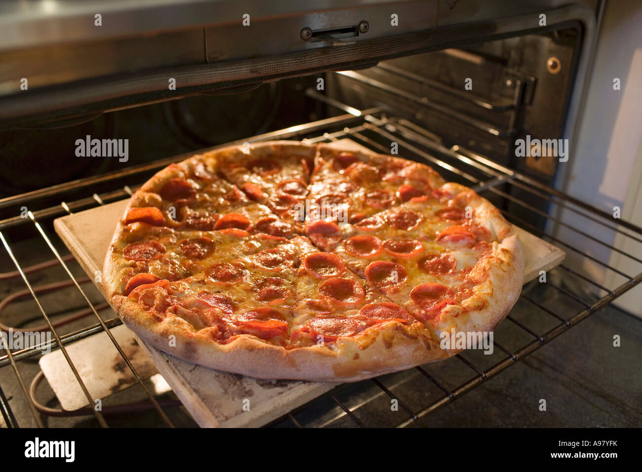 Warming up pepperoni pizza in oven FoodCollection Stock Photo - Alamy