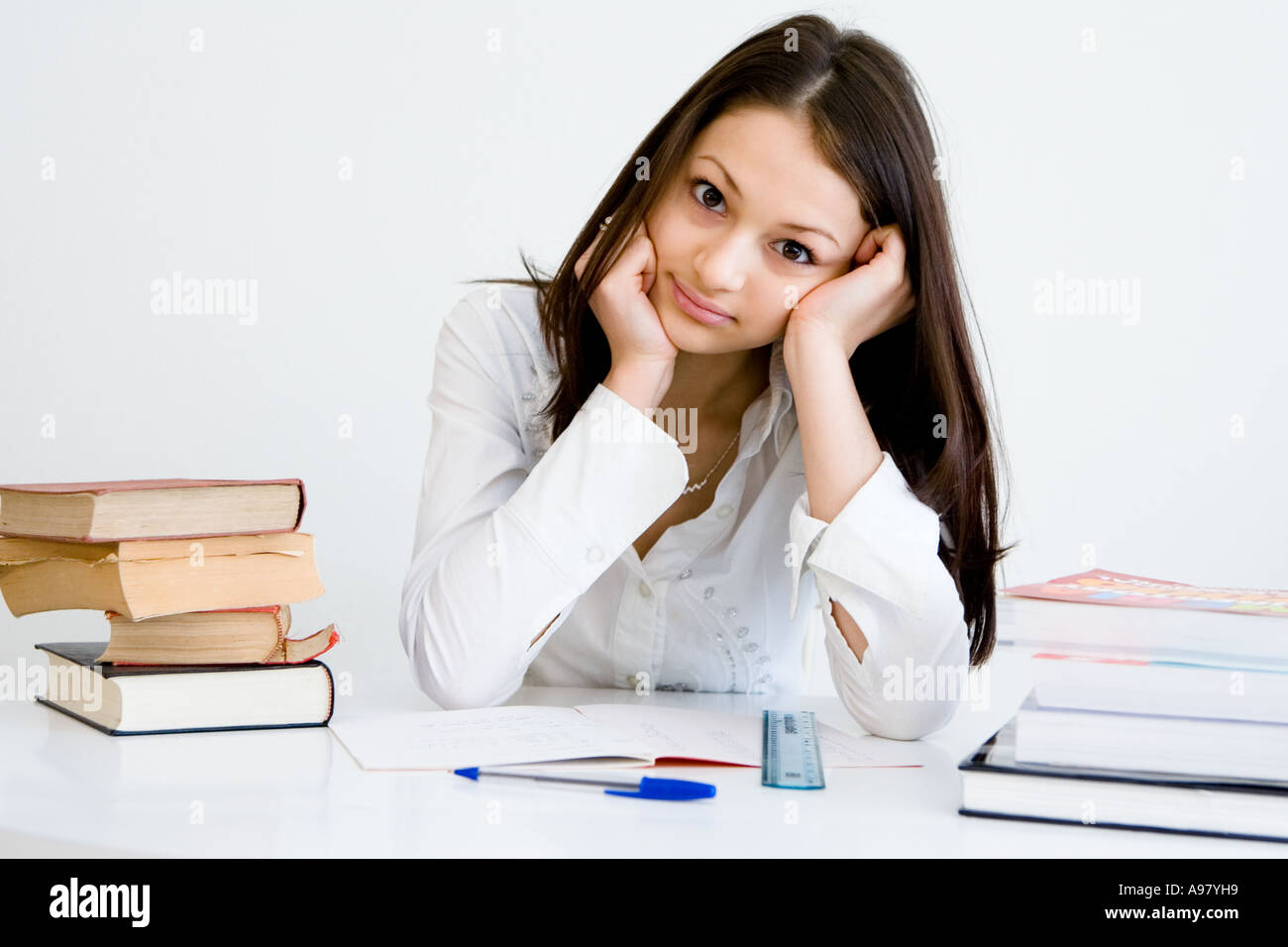 Young pretty girl fed up studying for exams Stock Photo - Alamy