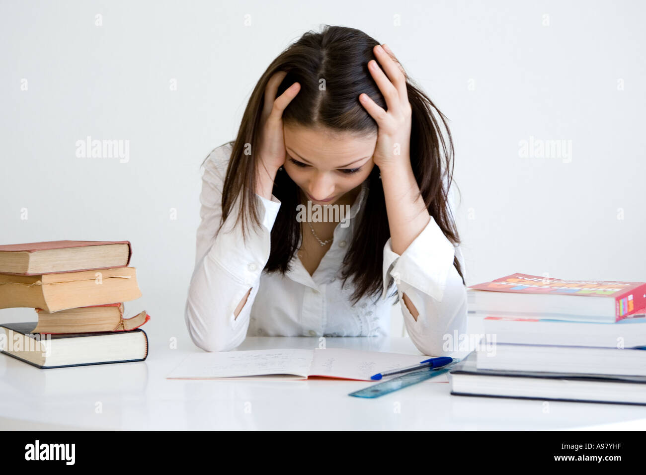 Young pretty girl fed up studying for exams Stock Photo - Alamy