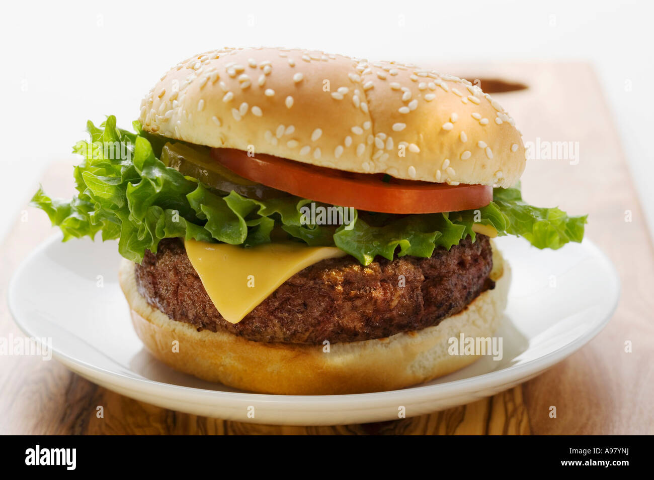 Cheeseburger with tomato and gherkin FoodCollection Stock Photo - Alamy
