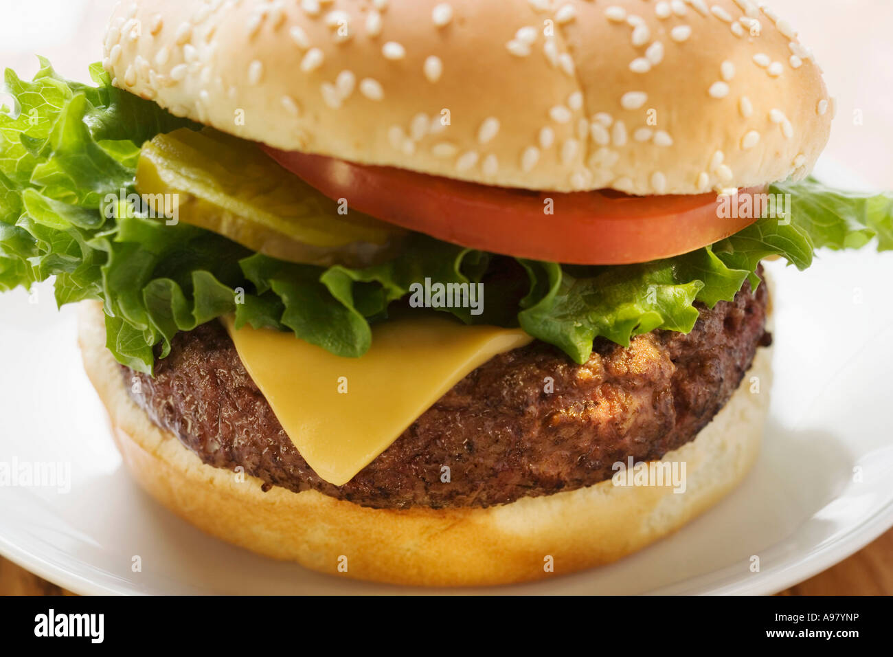 Cheeseburger with tomato and gherkin FoodCollection Stock Photo - Alamy