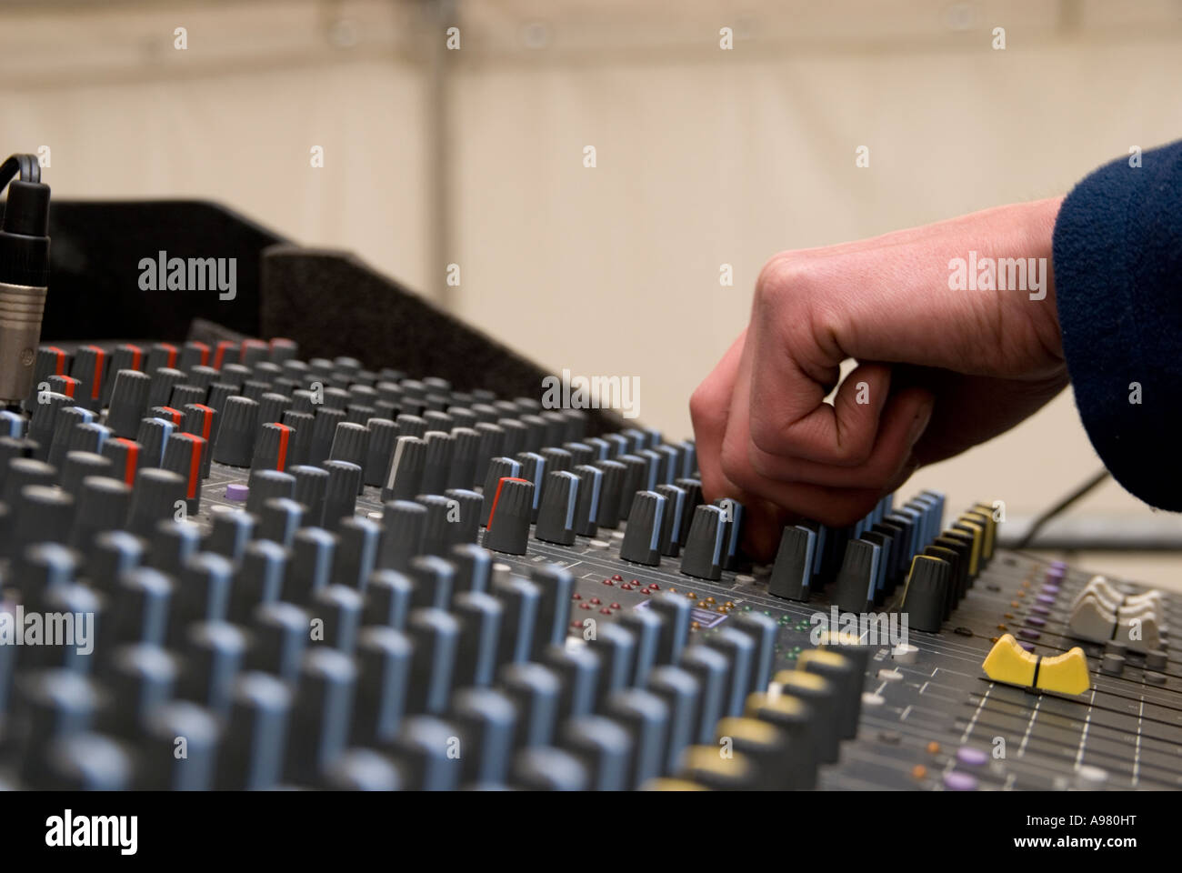 Technician adjusting controls on an analogue mixing desk Stock Photo ...