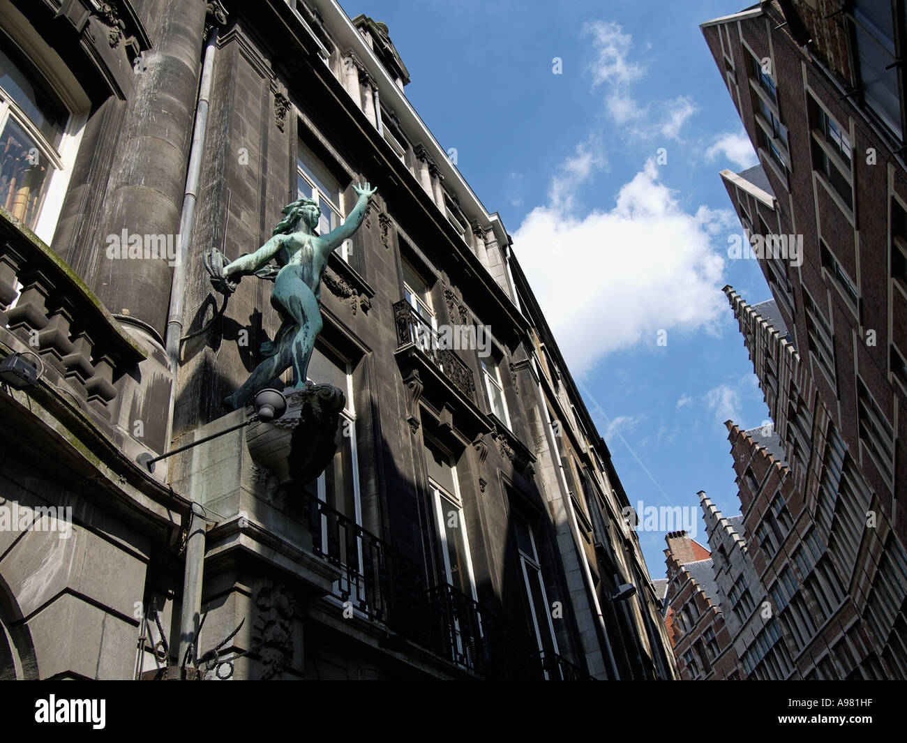 Street in historic city center of Antwerpen Belgium with bronze statue ...