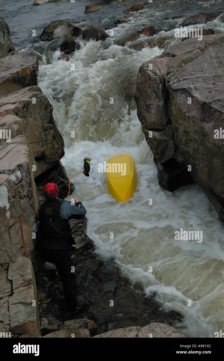 Whitewater kayaking, upturned kayak with man in water Stock Photo - Alamy