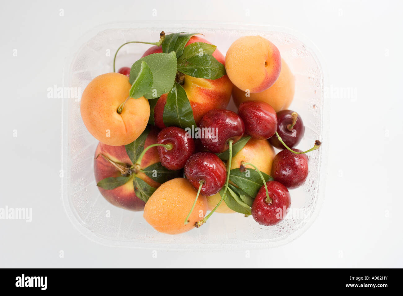 Nectarines apricots and cherries in plastic punnet FoodCollection Stock ...