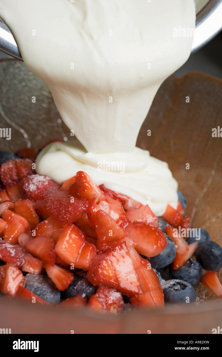 Pouring quark cream over berries FoodCollection Stock Photo - Alamy