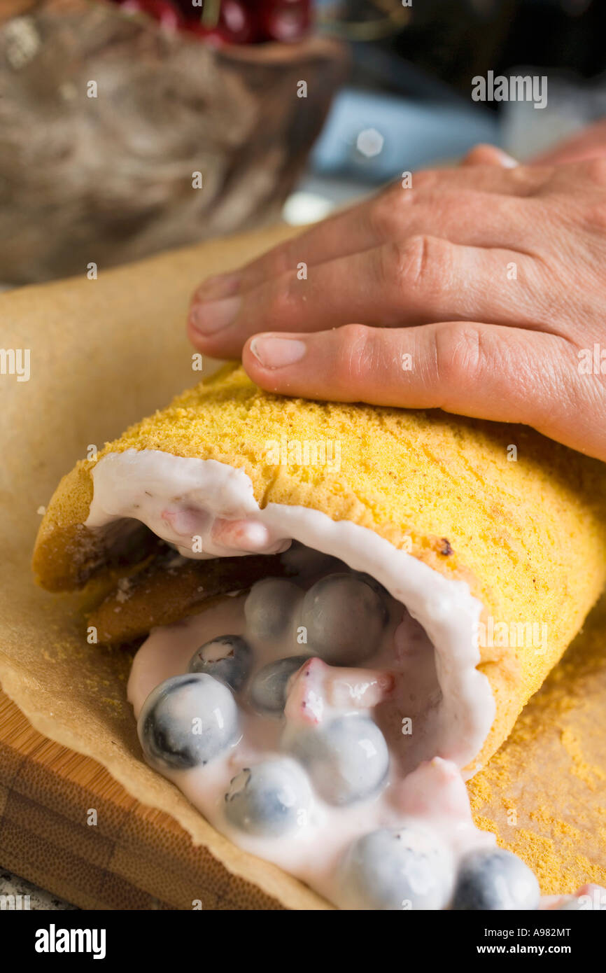 Rolling up a sponge roulade FoodCollection Stock Photo - Alamy