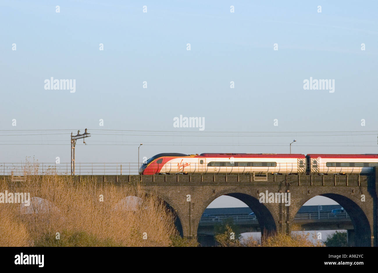 Virgin train crossing railway bridge at Runcorn Cheshire Stock Photo ...