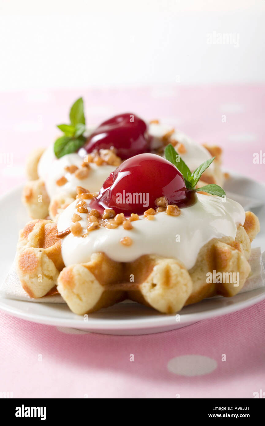 Waffles with vanilla cream and cherries FoodCollection Stock Photo - Alamy