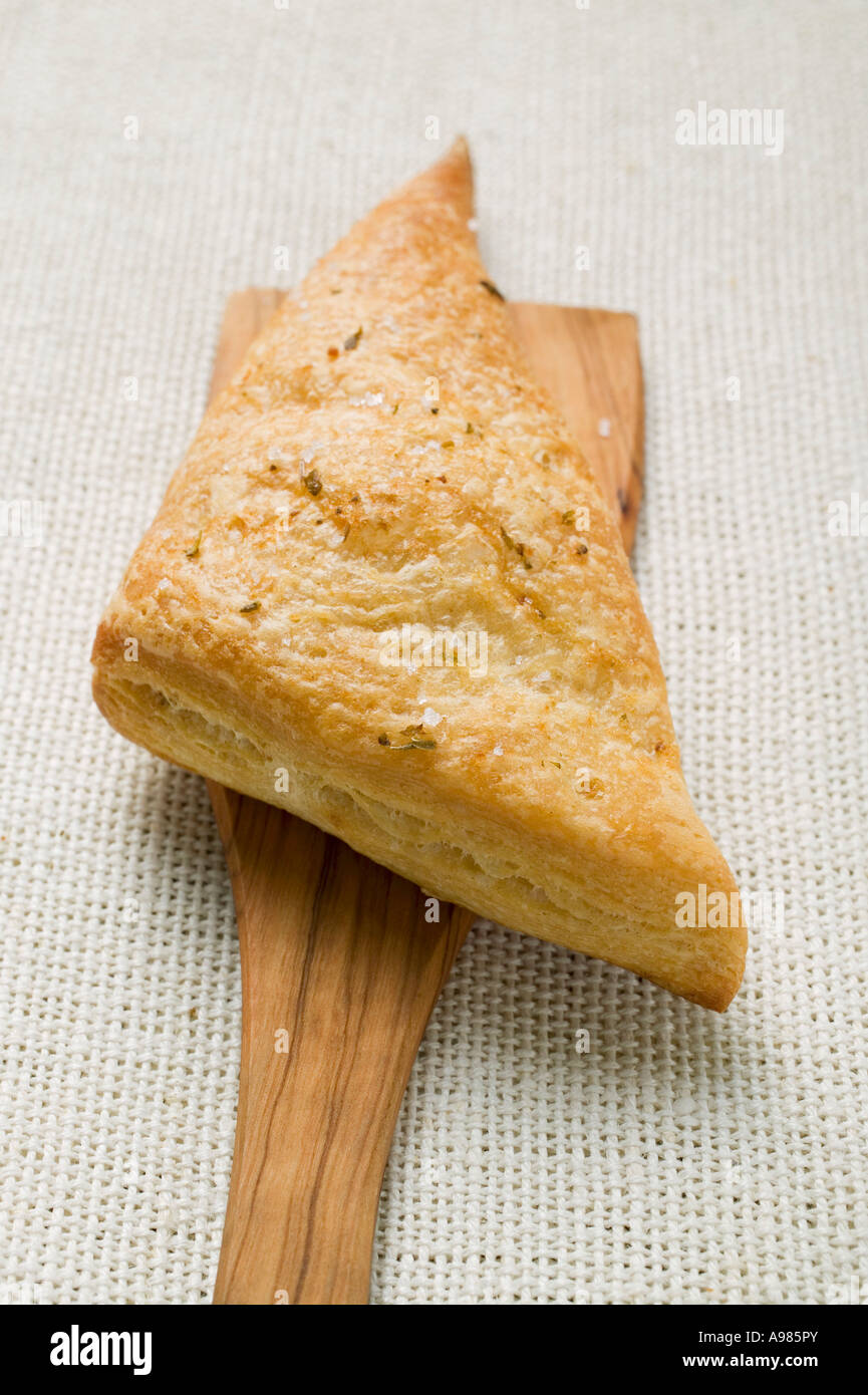 Triangular savoury puff pastry pasty on server FoodCollection Stock ...