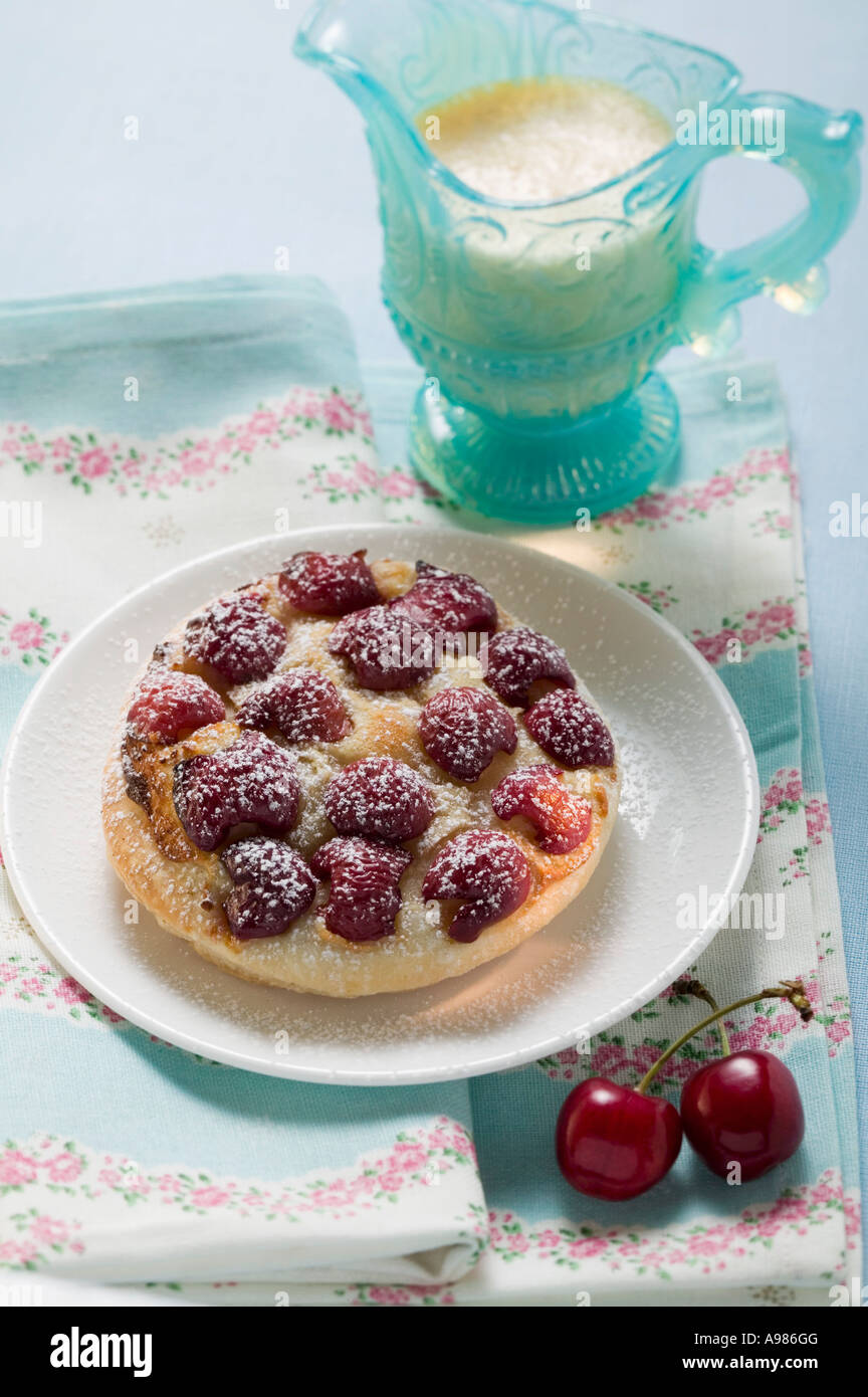 Cherry tart with icing sugar and custard FoodCollection Stock Photo - Alamy