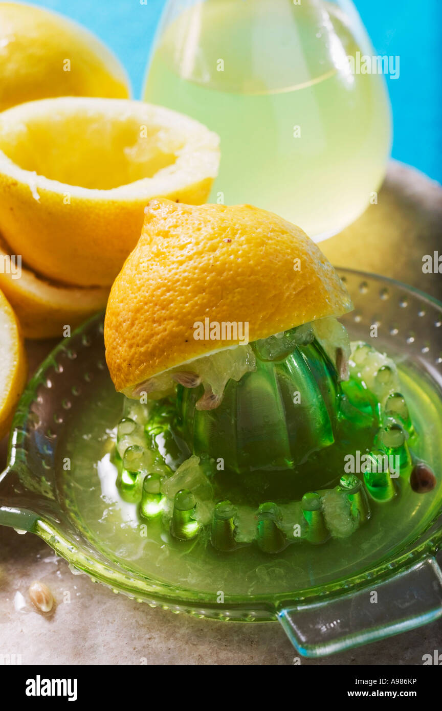 Squeezed lemons with lemon squeezer and lemon juice FoodCollection ...