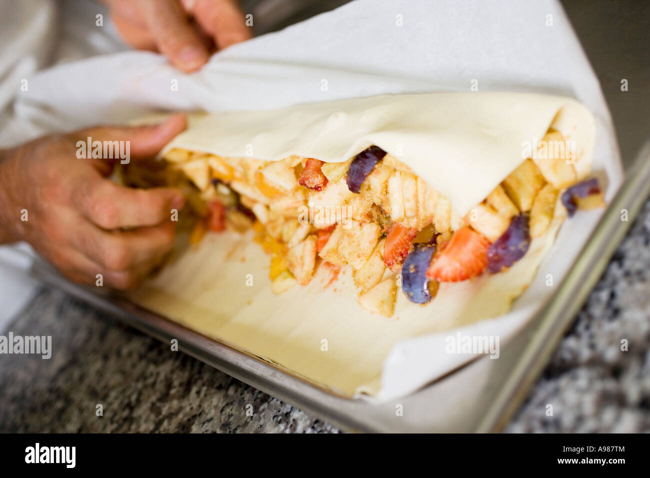 Making fruit strudel rolling up the strudel FoodCollection Stock Photo ...
