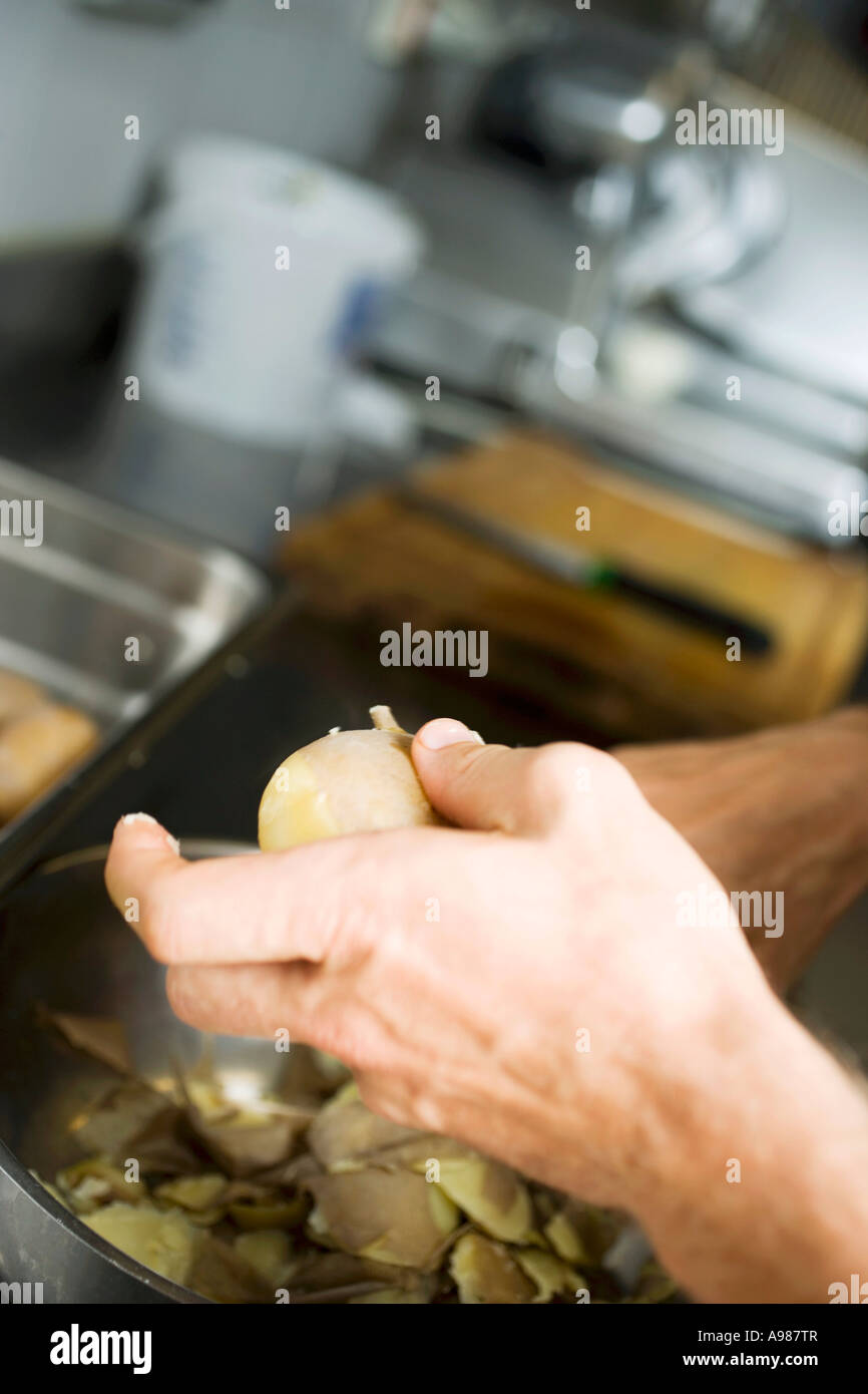 Peeling a cooked potato FoodCollection Stock Photo - Alamy