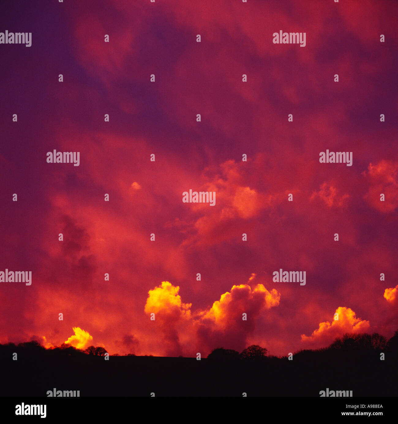 Powerful and very dramatic sunset with fiery coloured tinted clouds ...