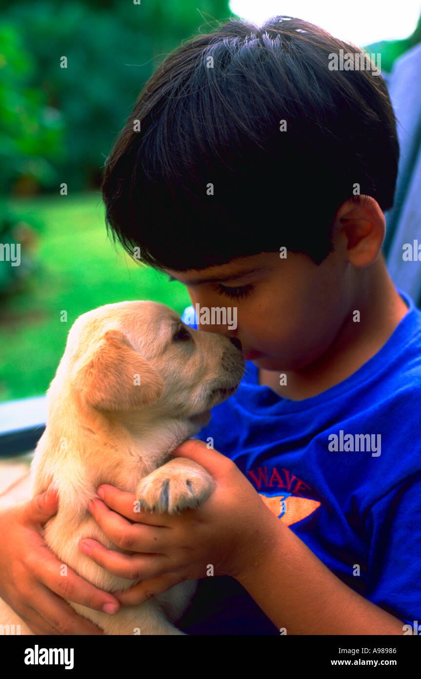 Boy with dog cuddling animals hi-res stock photography and images - Alamy
