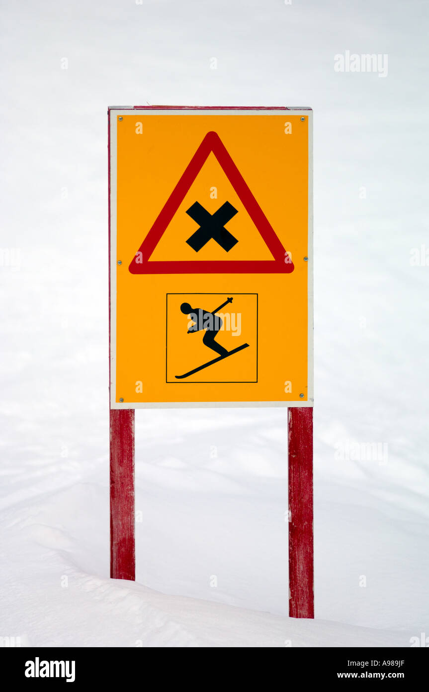 Bright yellow warning sign in skiing area Stock Photo - Alamy