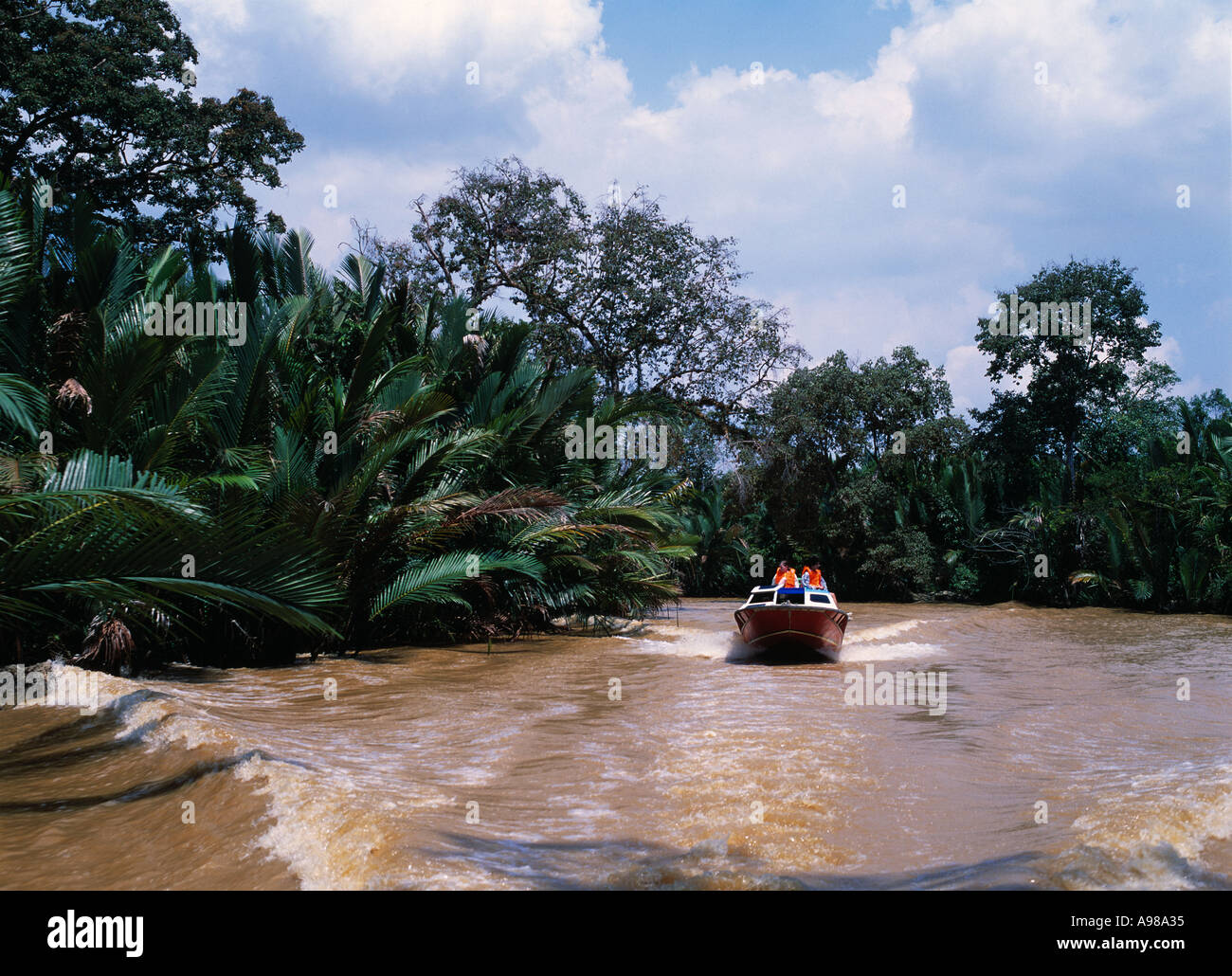 A speed boat travelling up river Stock Photo - Alamy