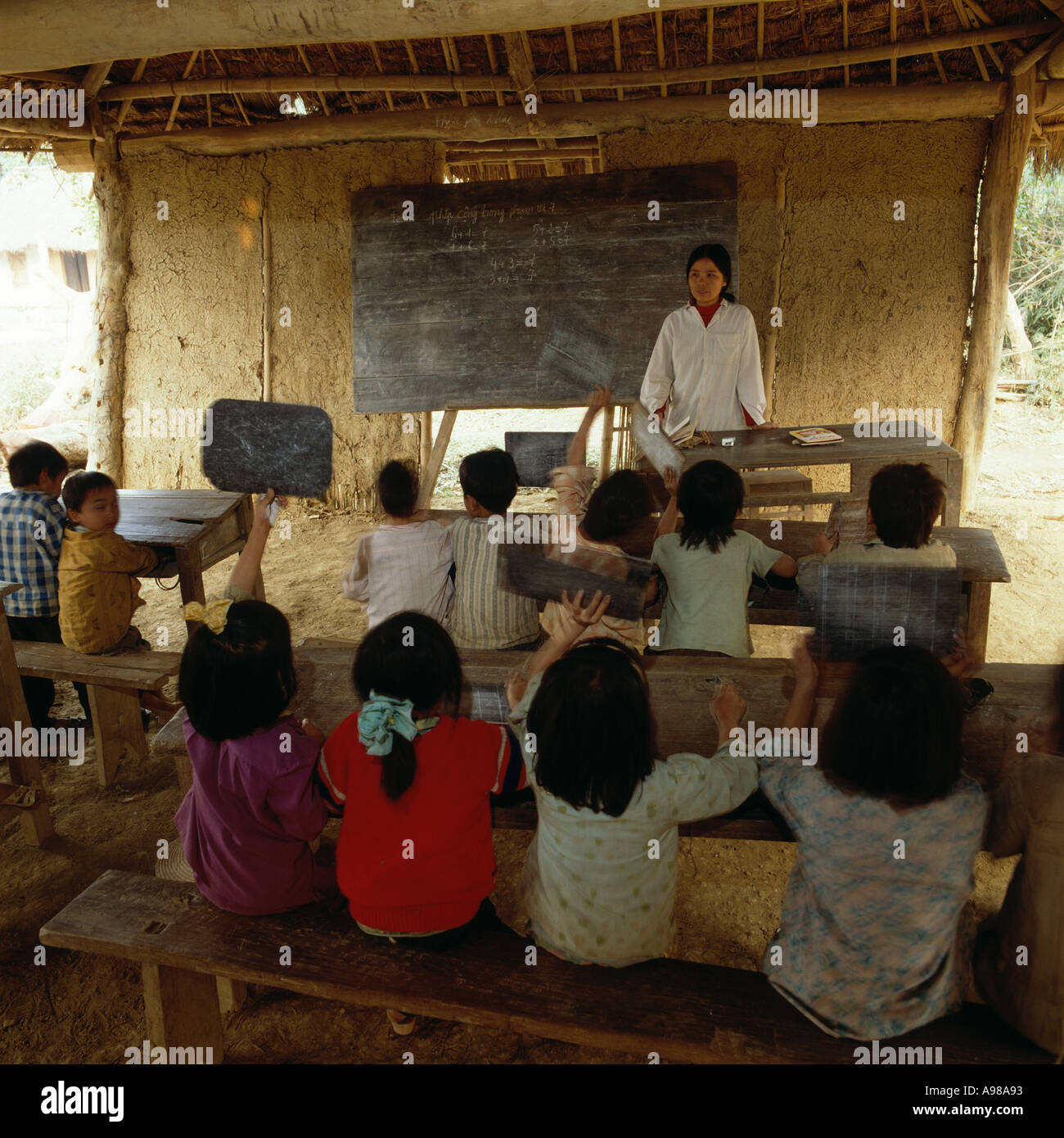 A class of students at school in a leaf hut Stock Photo - Alamy
