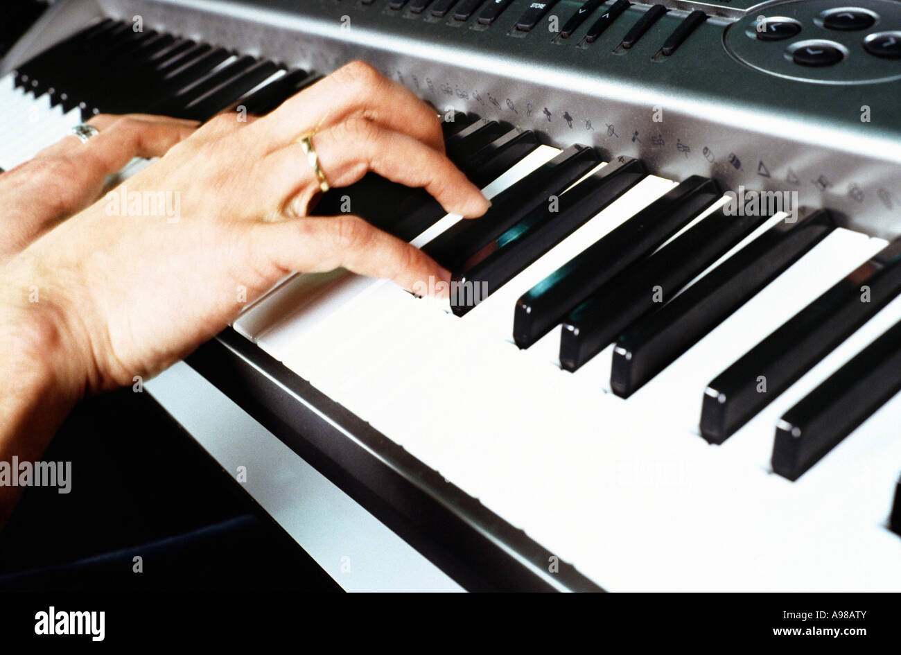 hands playing an electric keyboard Stock Photo - Alamy