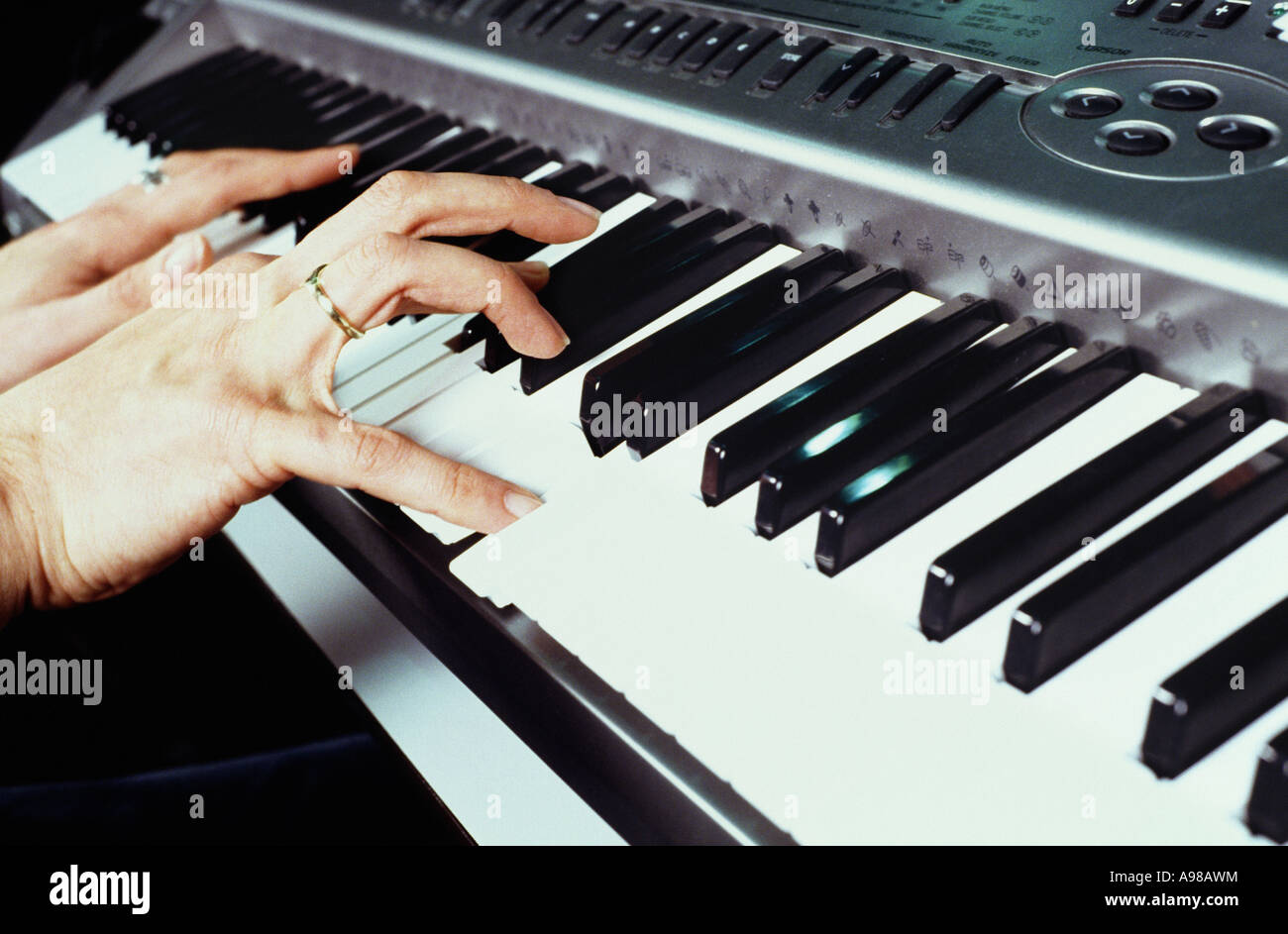 hands playing an electric keyboard Stock Photo - Alamy