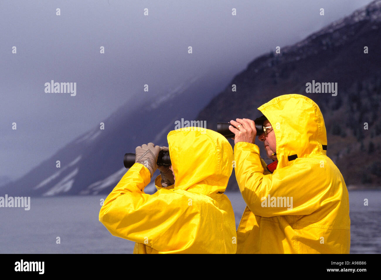 Alaska, Inside Passage, Couple with binoculars, birdwatching Stock ...