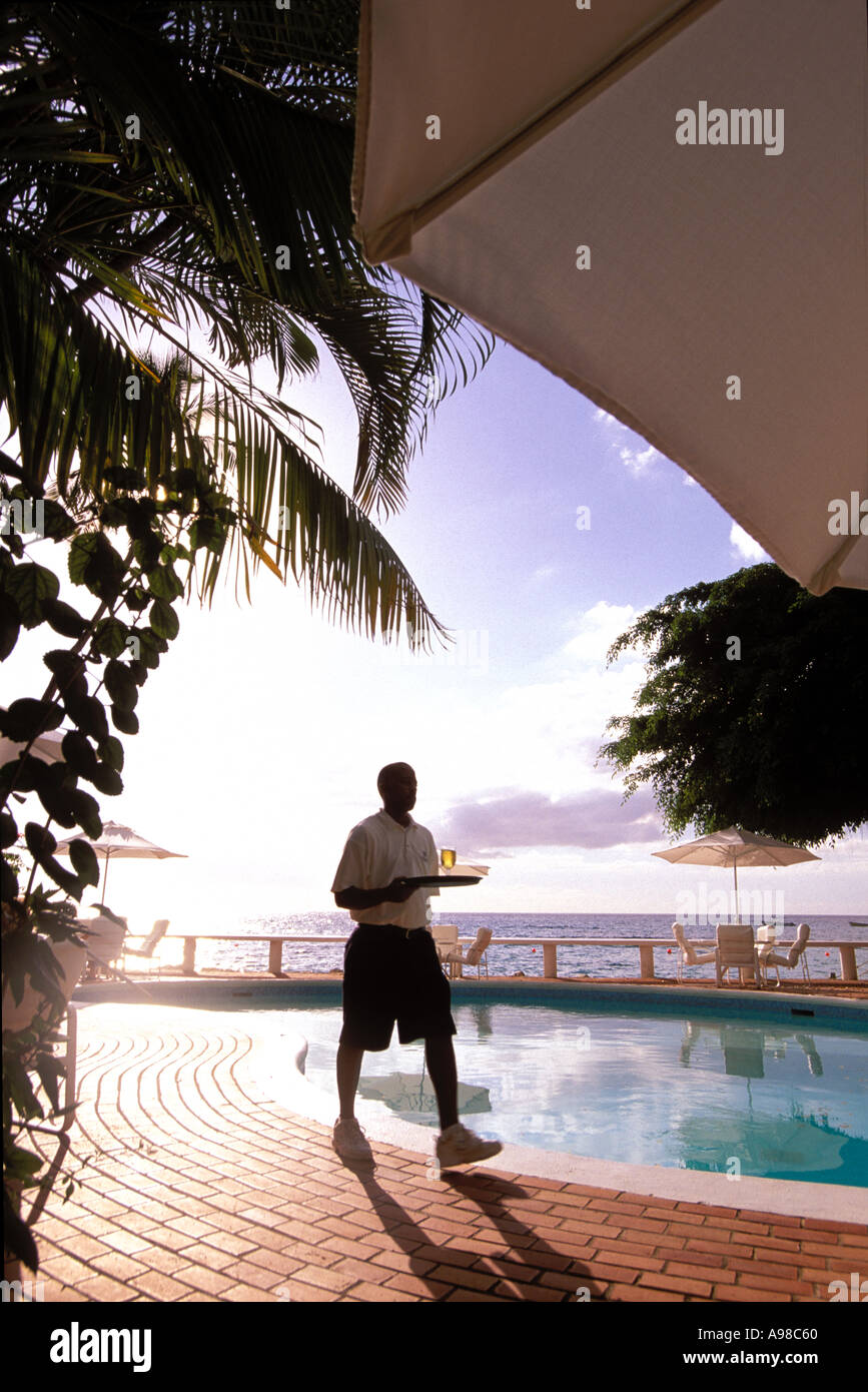 Barbados, St Peter, Cobblers Cove, waiter at pool Stock Photo - Alamy