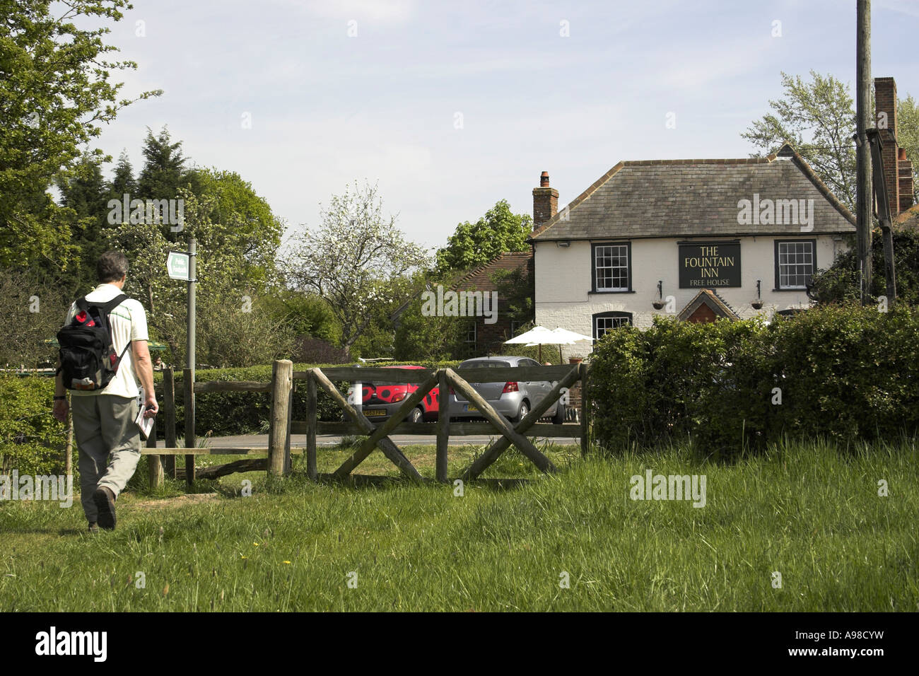 A walker approaches The Fountain Inn, Ashurst, West Sussex, UK Stock ...