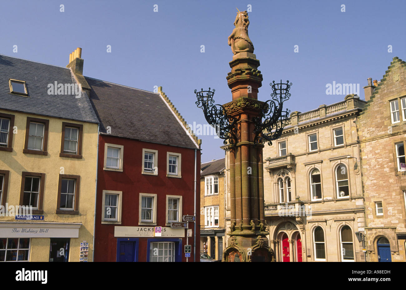 Old houses and Mercat Cross in Jedburgh town centre and shops on Market ...