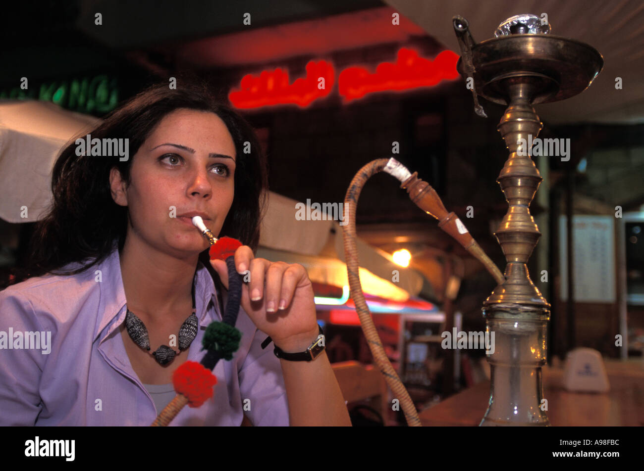 Young woman smoking argileh/nargileh water pipe (sheesha), Byblos ...