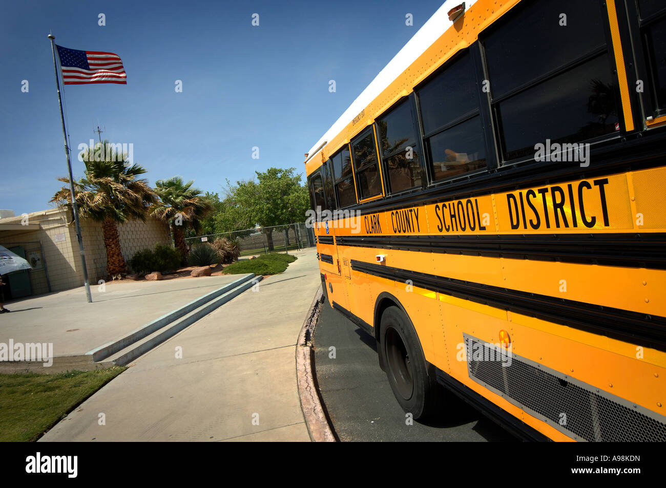 a bright yellow school bus outside an elementary school in Las Vegas ...