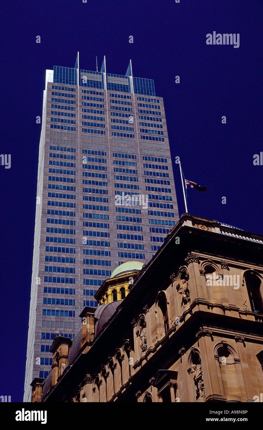 Modern Skyscraper rising high behind a colonial building in downtown ...
