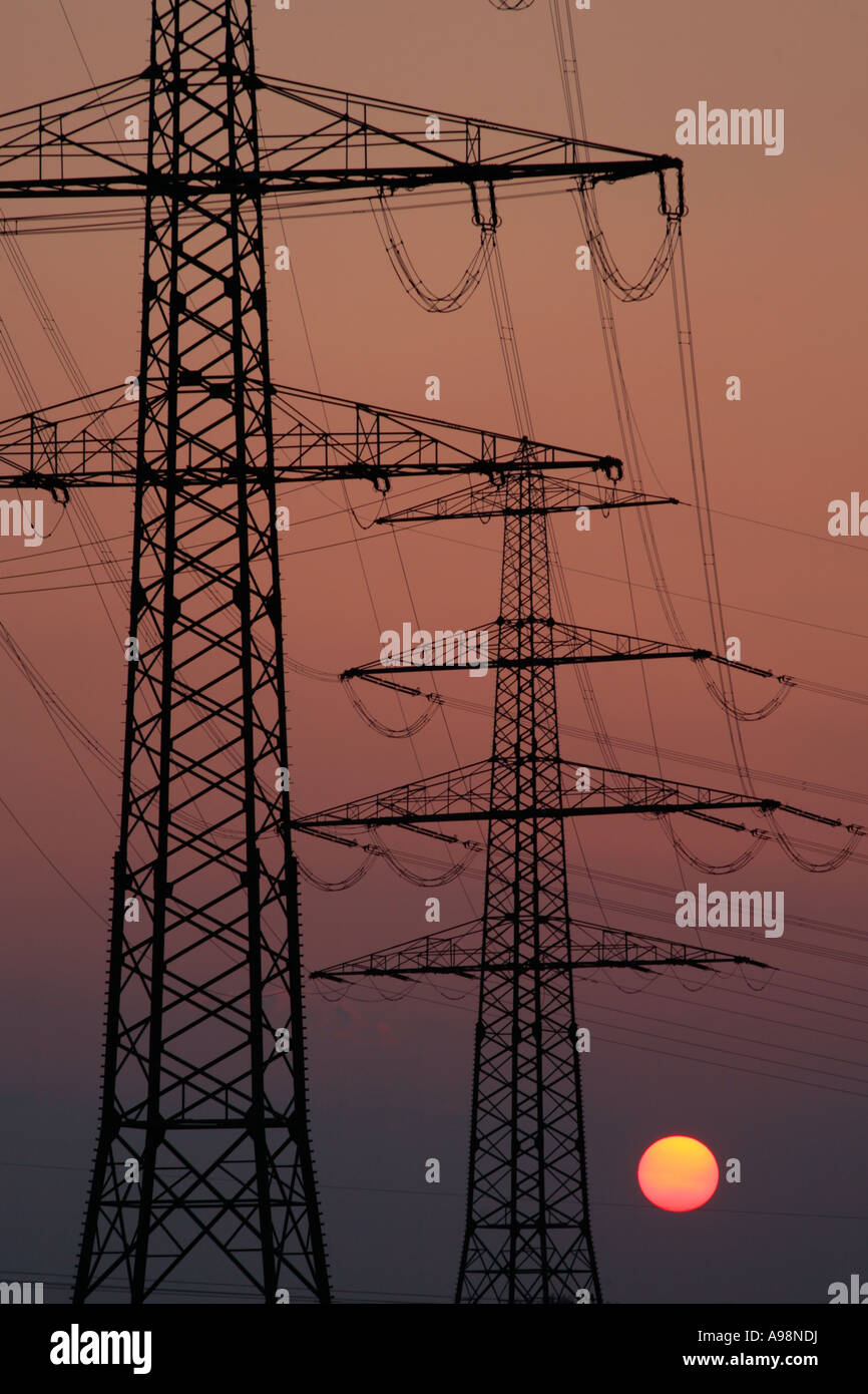 pylons beside the setting sun Stock Photo - Alamy