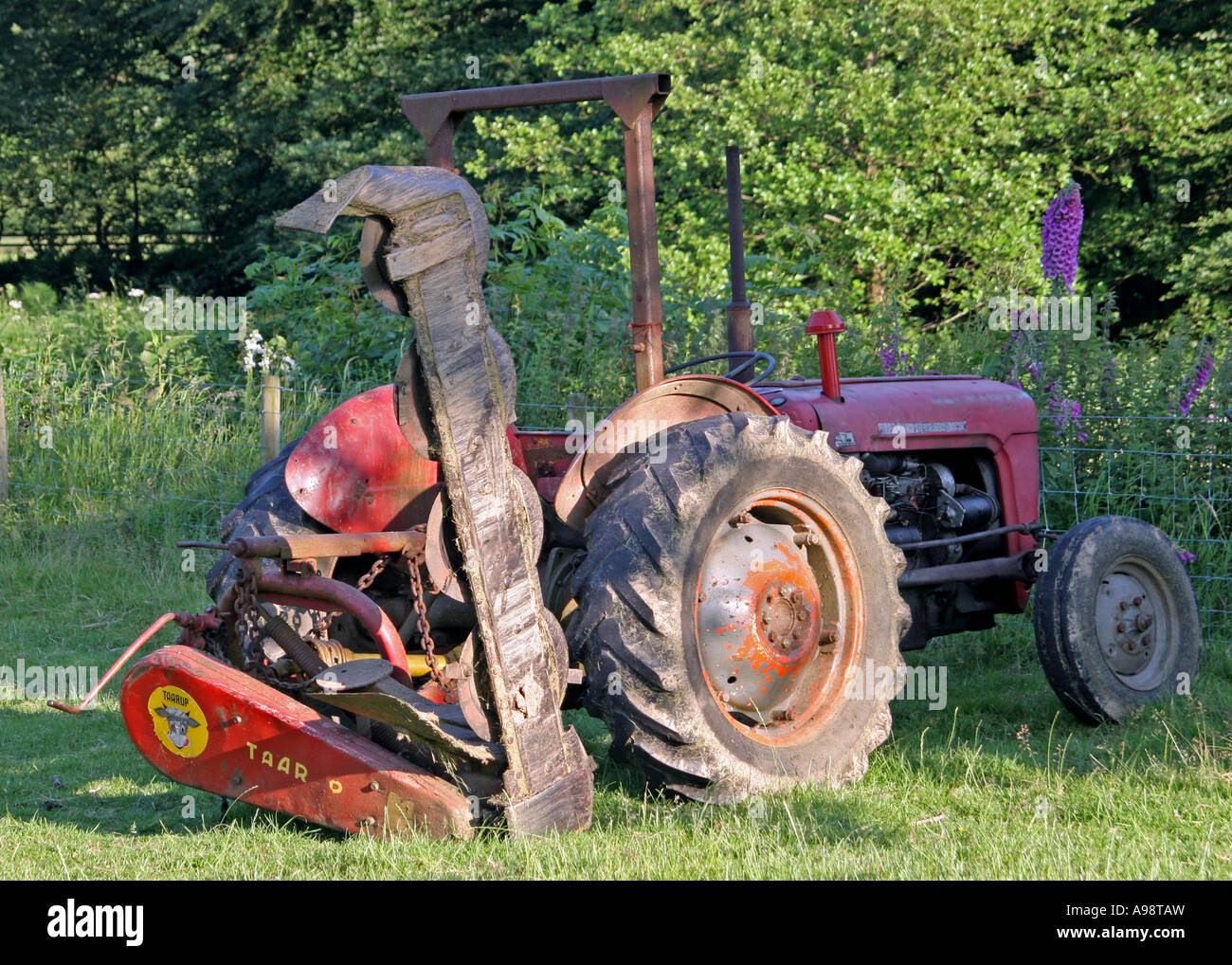 Rustic tractor discarded outside Stock Photo - Alamy