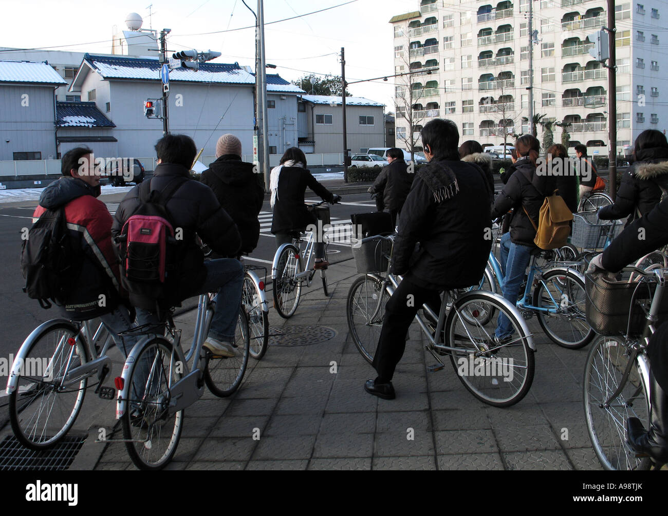 Cyclist waiting on street light Stock Photo - Alamy