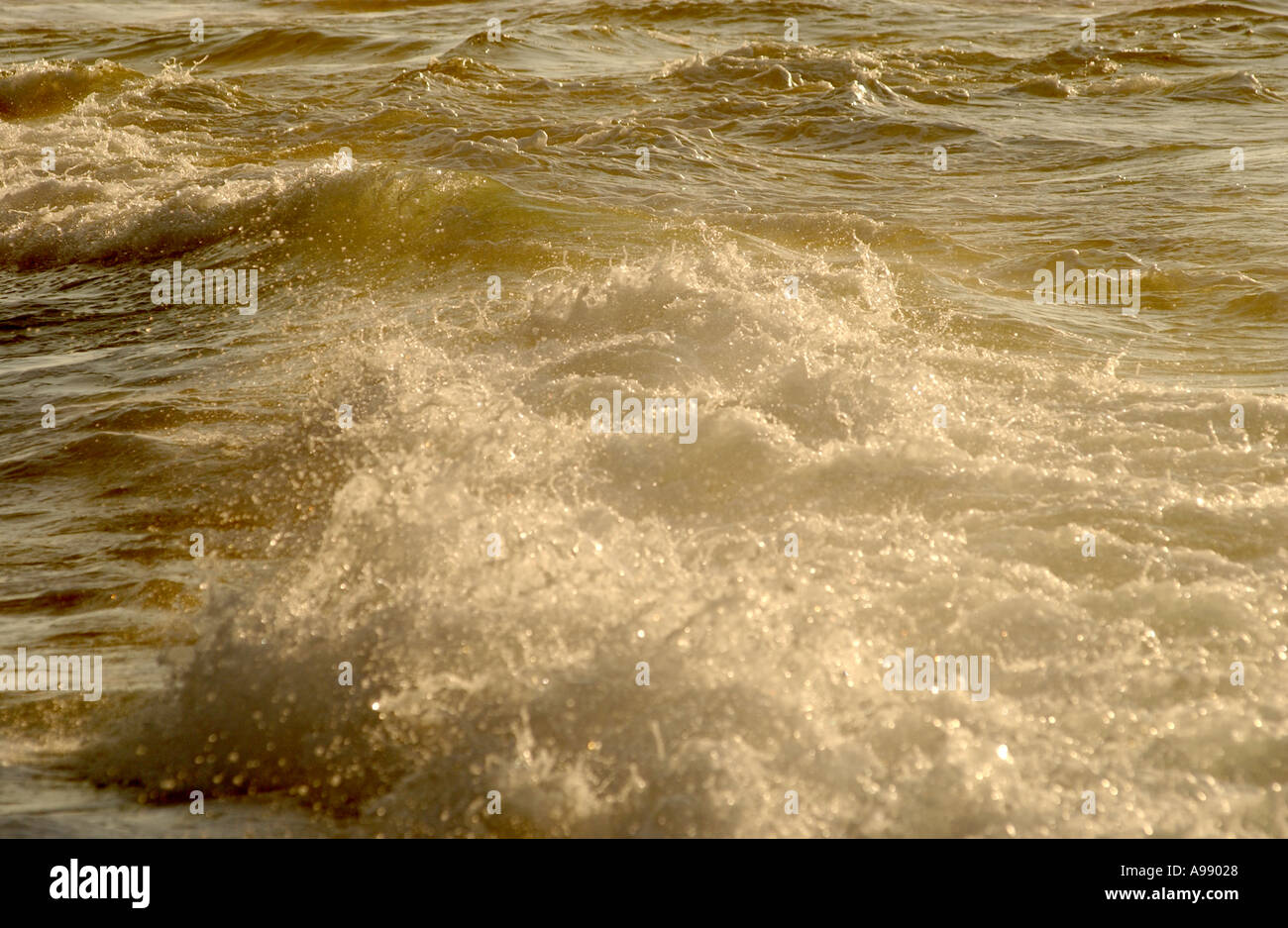 Color horizontal color image of surf at sunset Stock Photo - Alamy