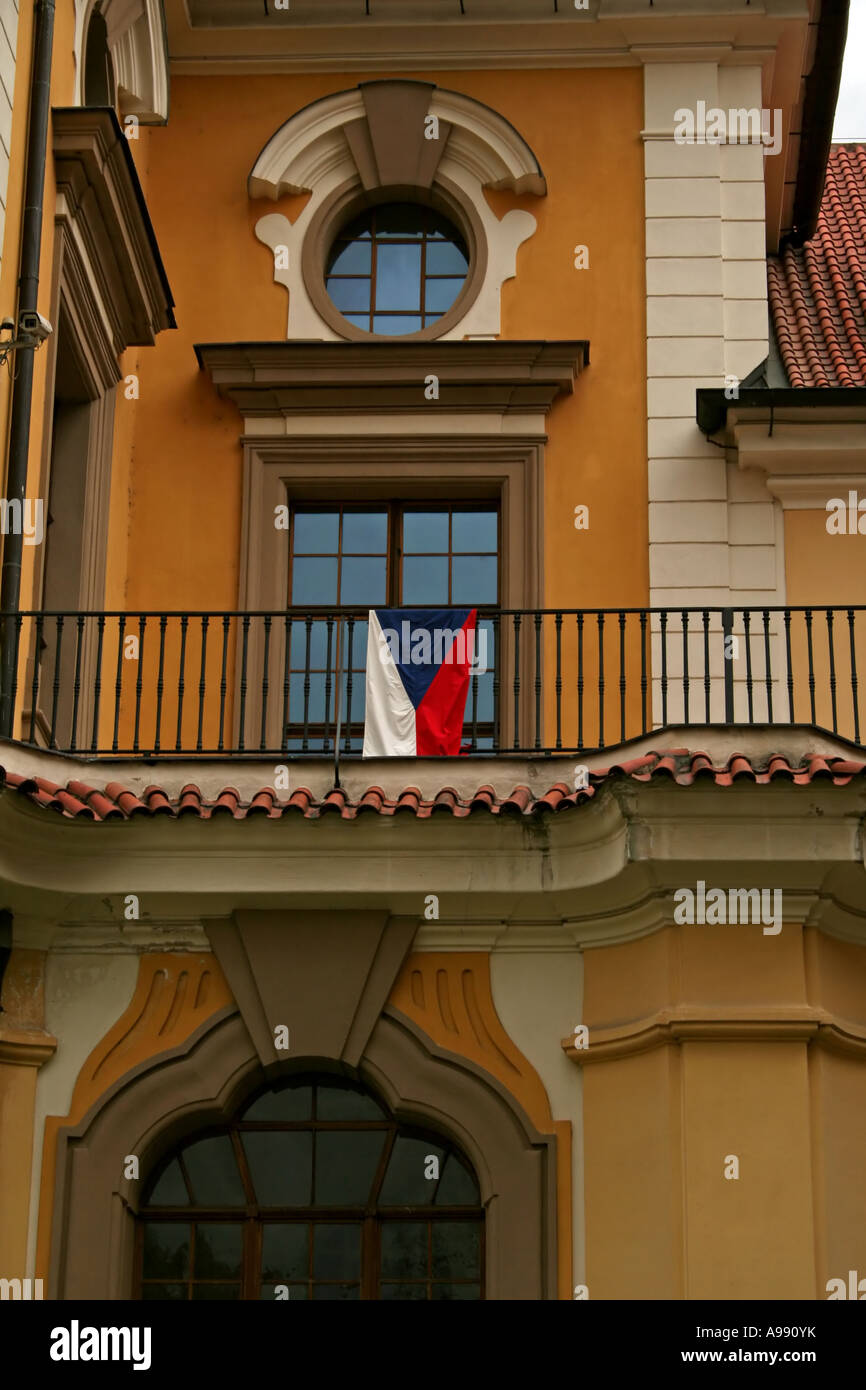 An elegant building facade with a balcony displaying the Czech Republic ...